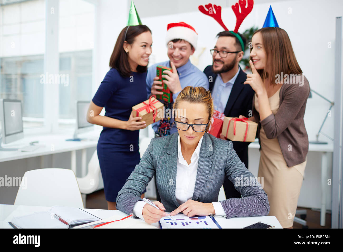 Several employees preparing Christmas surprise to their colleague Stock ...