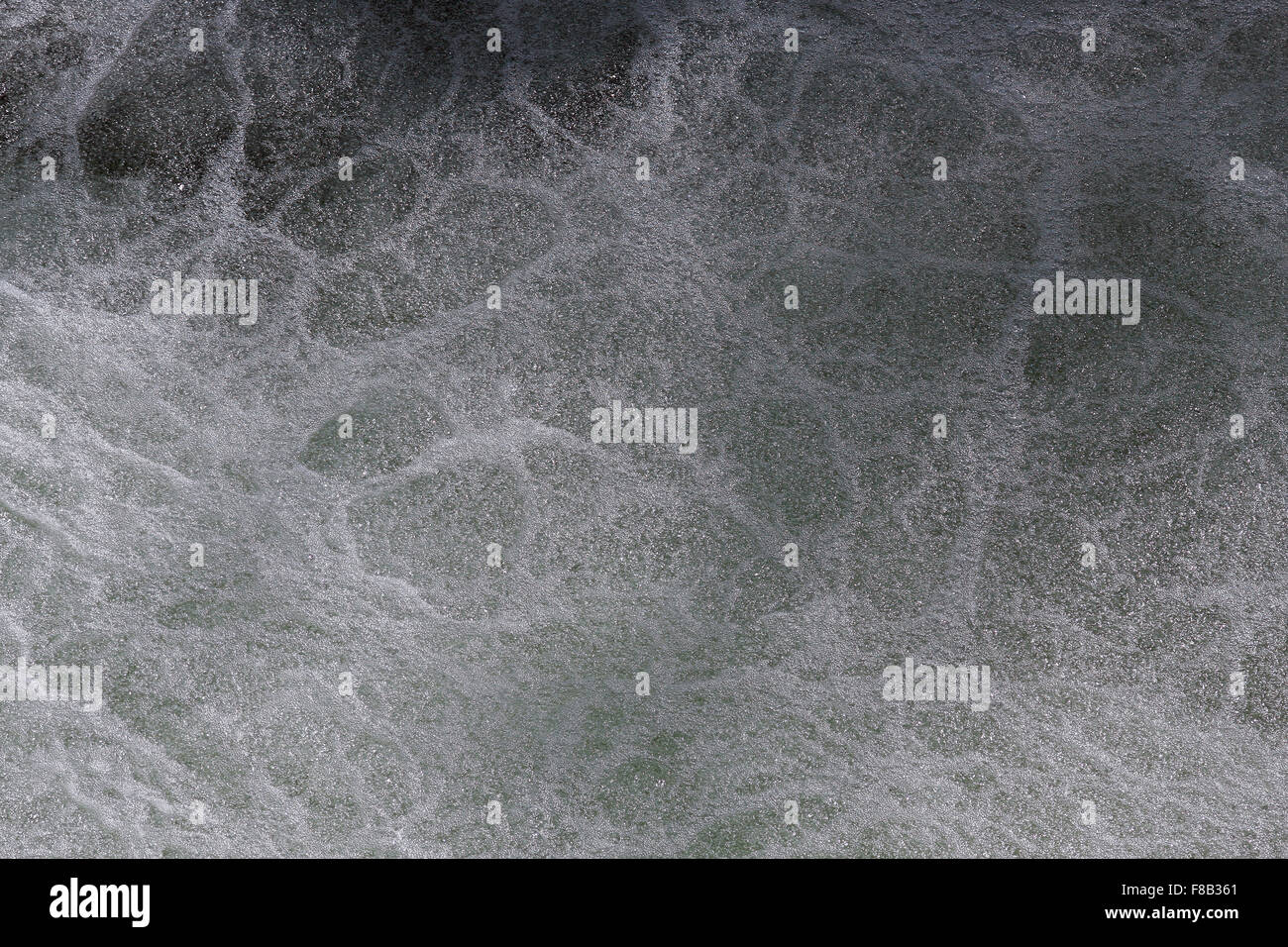 Water-world from above. A river stream from a cliff above, eddies and ...