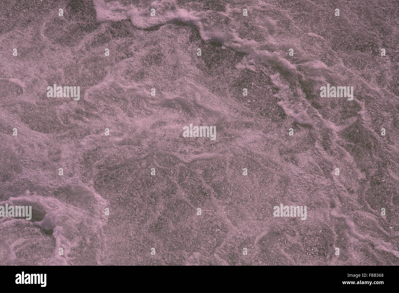 Water-world from above. A river stream from a cliff above, eddies and ...