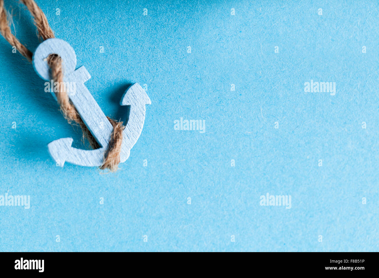 the small anchor close-up on a blue background Stock Photo - Alamy