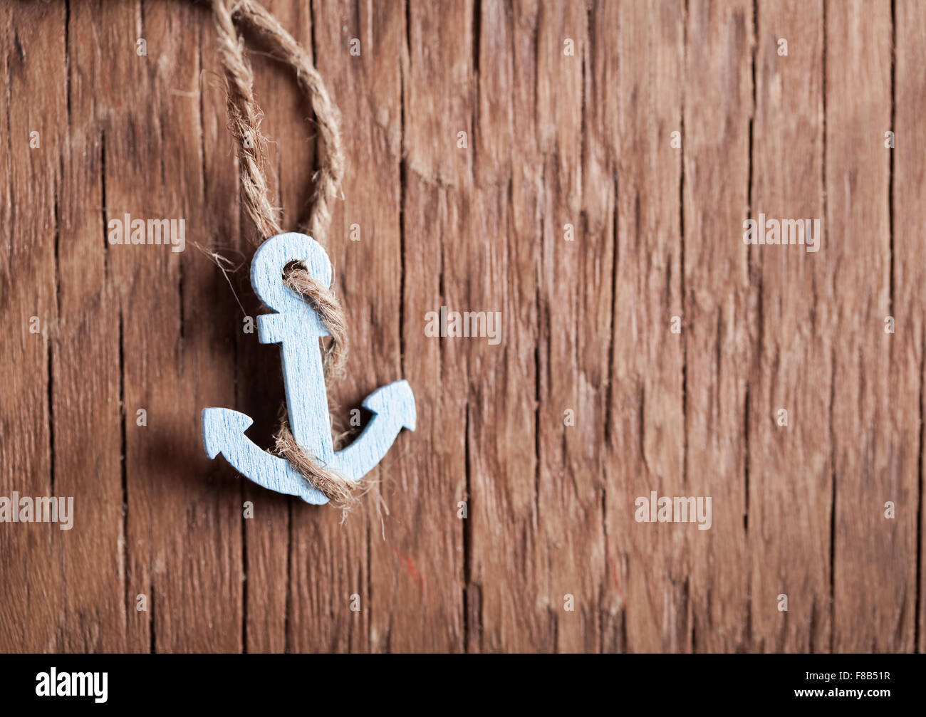 small anchor close-up on a wooden vintage background Stock Photo - Alamy