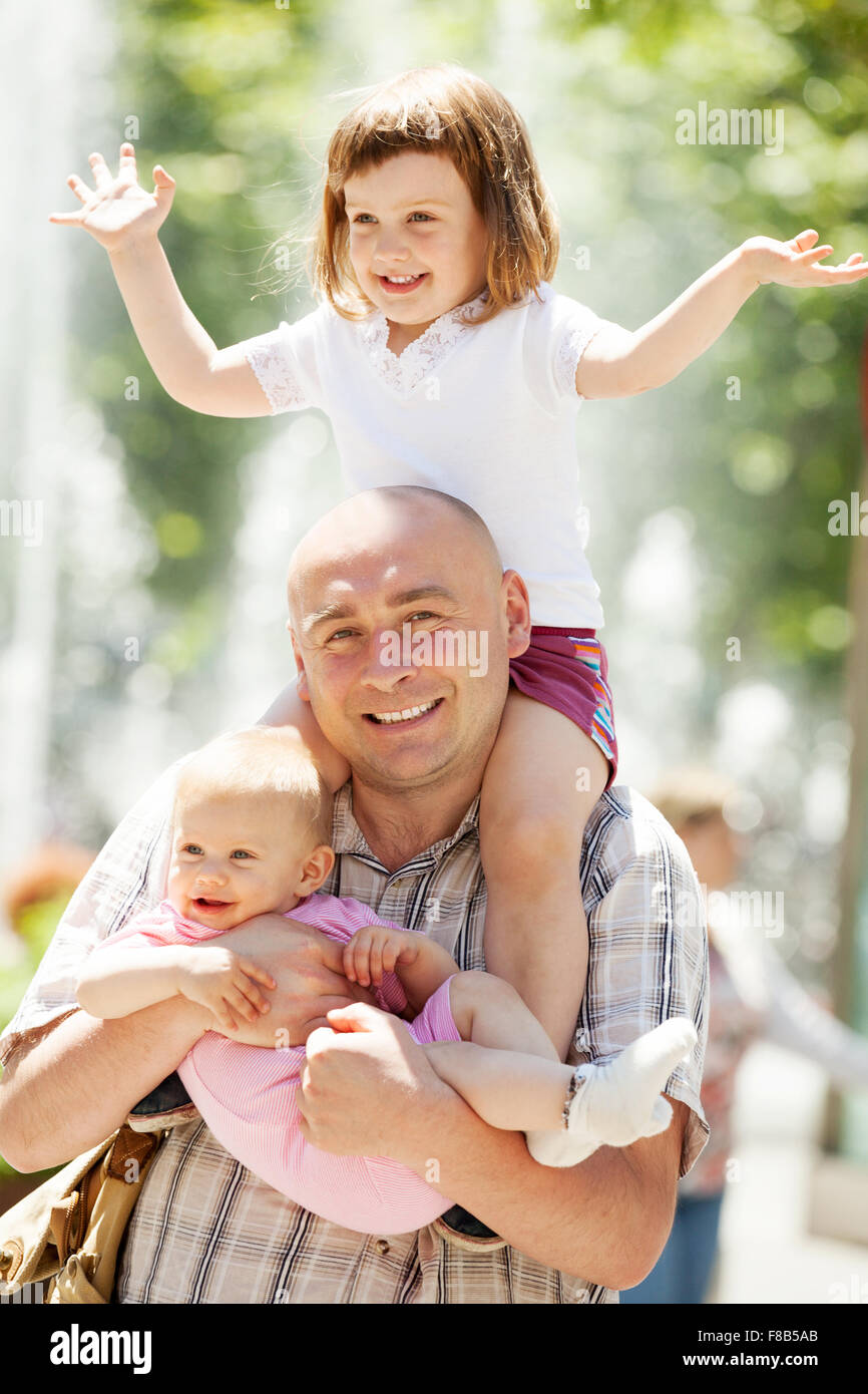 Outdoor portrait of happy father with two adorable daughters Stock ...