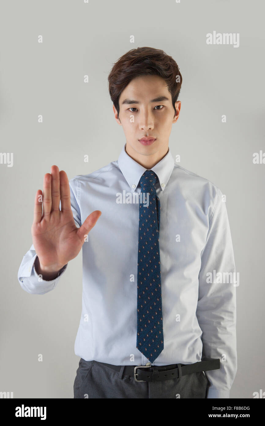 Businessman touching a screen with his palm and staring forward Stock ...