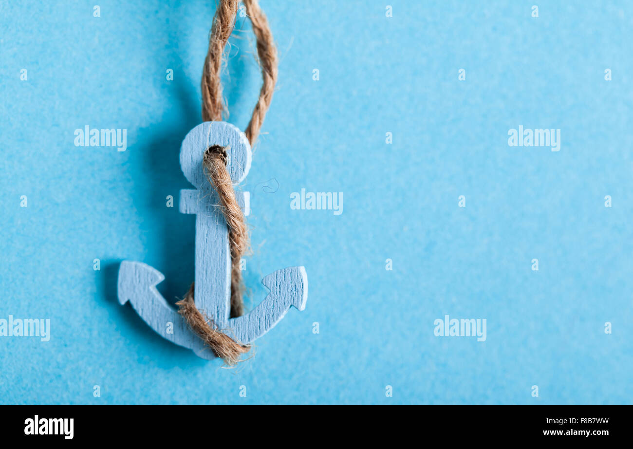 the small anchor close-up on a blue background Stock Photo - Alamy
