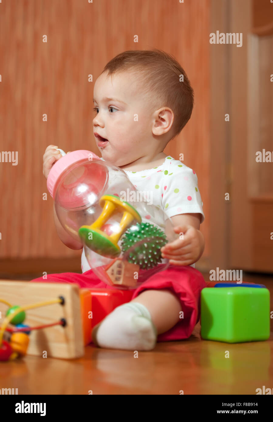 Year-old child with toys on the floor Stock Photo - Alamy