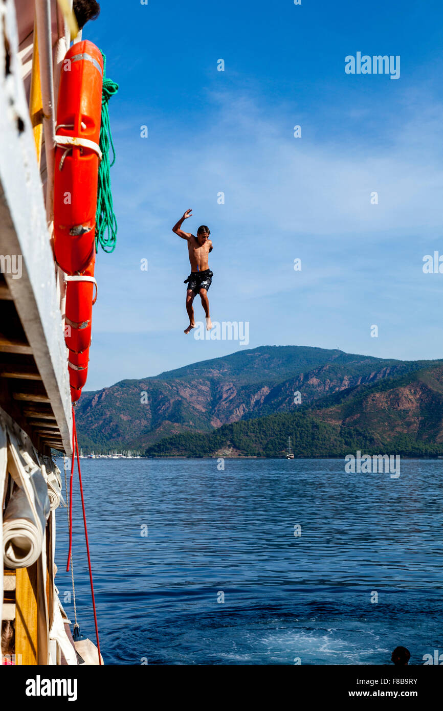 Boy jumping boat hi-res stock photography and images - Alamy