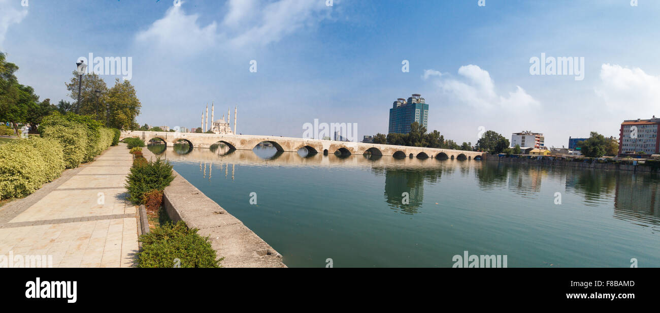 Side view of historical old stone bridge of Adana on Seyhan river, on ...