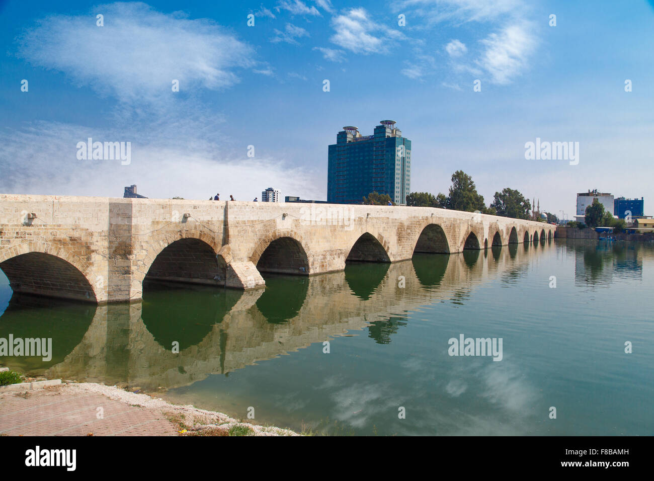 Side view of historical old stone bridge of Adana on Seyhan river, on ...