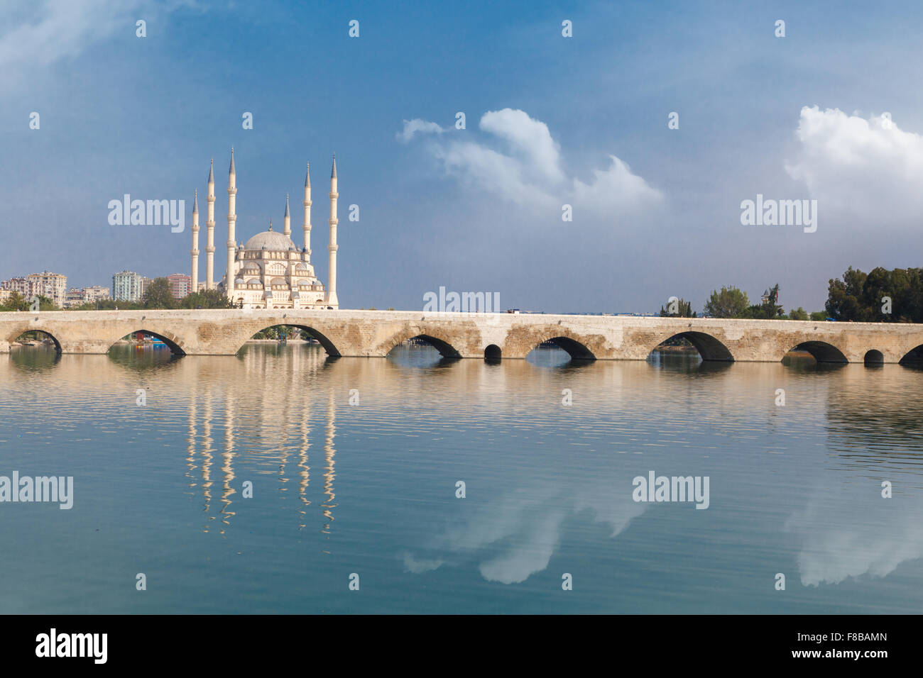 Side view of historical old stone bridge of Adana on Seyhan river, on ...