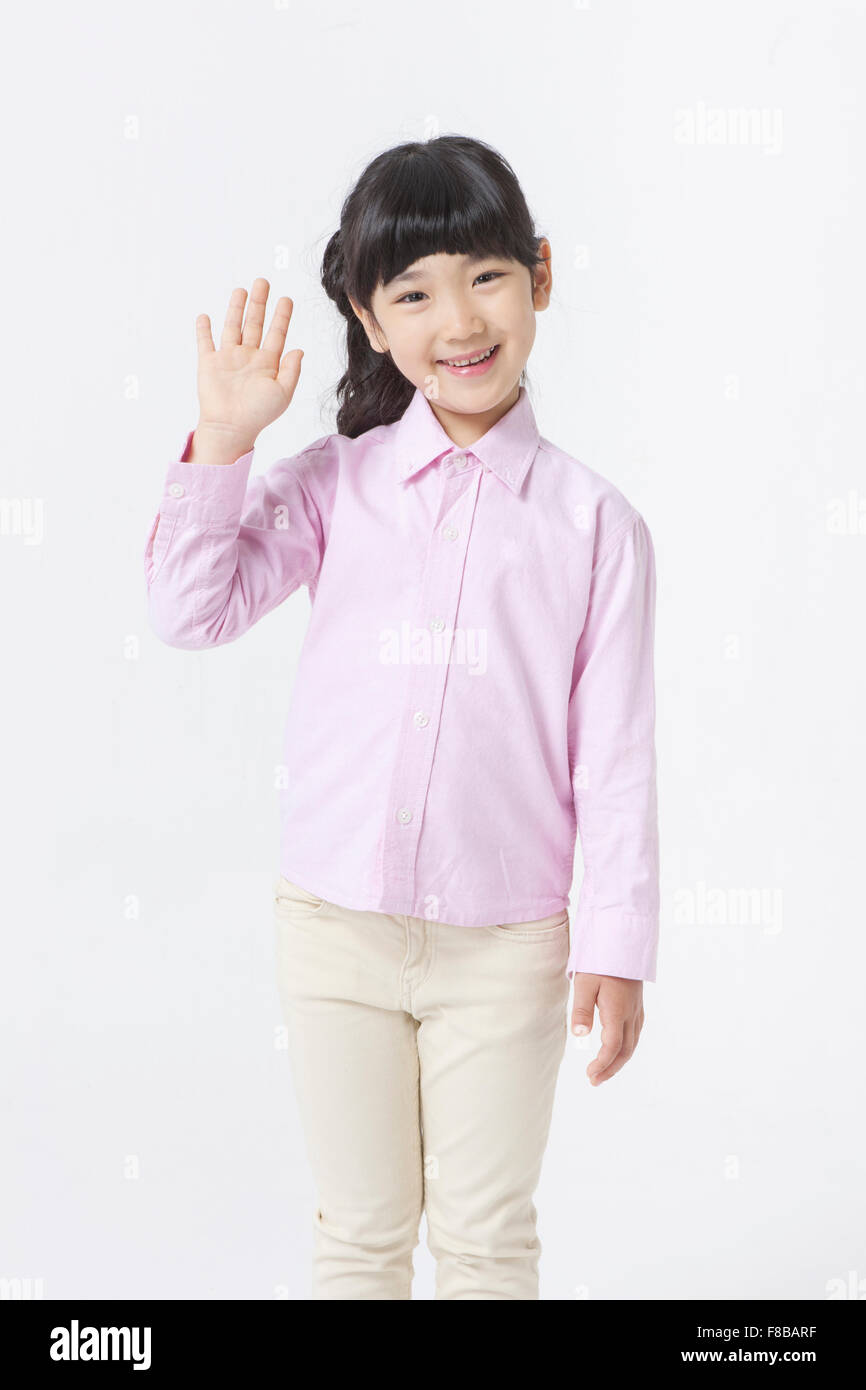 Young Korean girl in pink shirt waving her hand and smiling Stock Photo ...