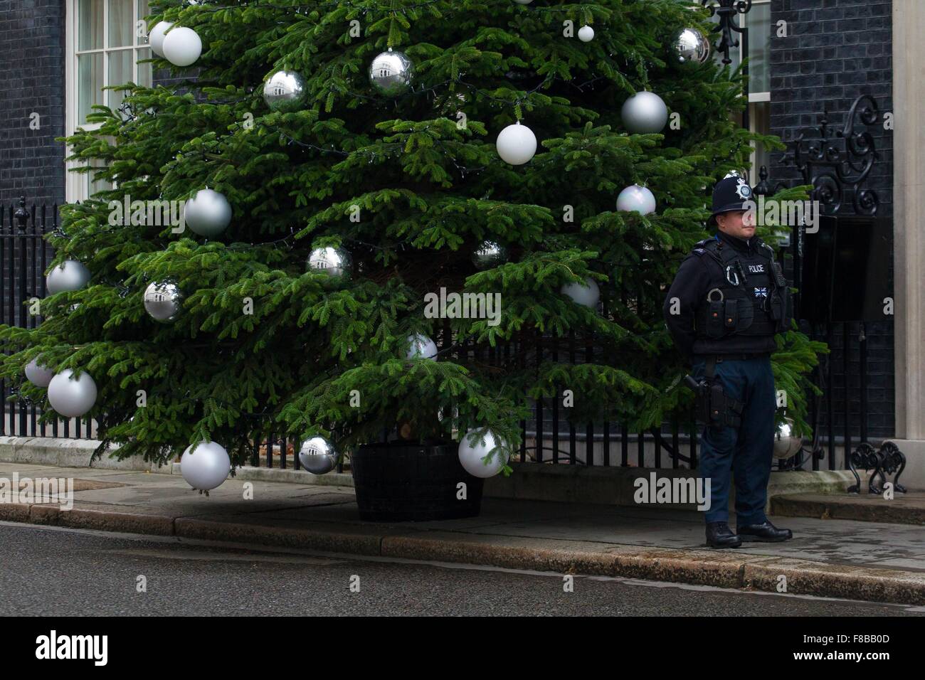 A Policeman stands by the Christmas tree outside number ten Downing ...