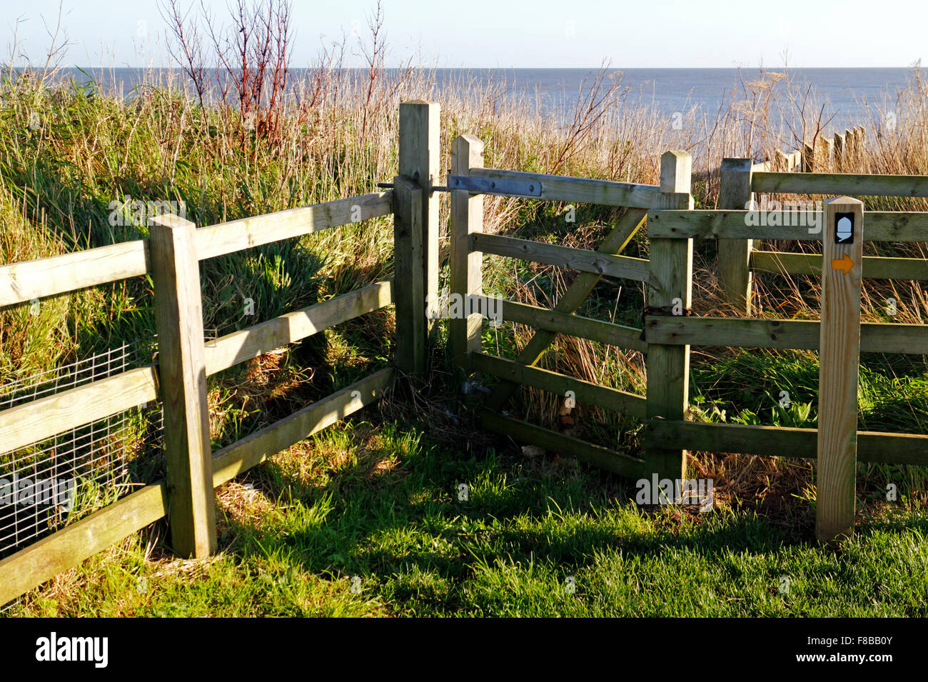 A kissing gate on a footpath cut off by falling cliffs and redirected ...