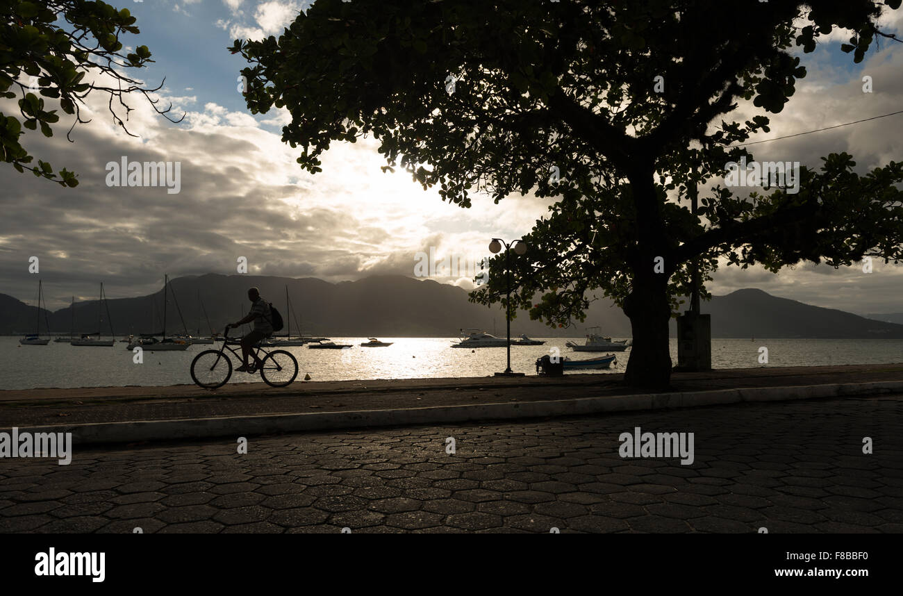 A cyclist riding a bike in Ilhabela, Brazil Stock Photo - Alamy
