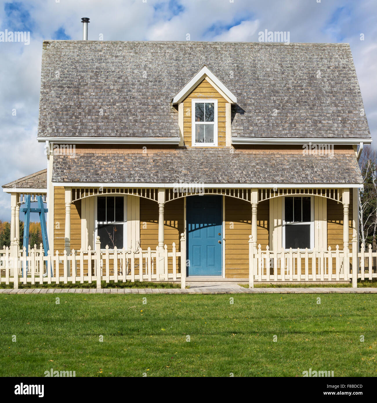 A tiny old fashioned house with a picket fence Stock Photo - Alamy