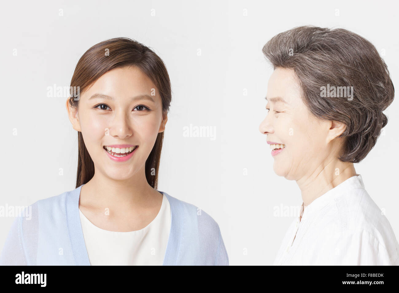 Daughter staring forward with a smile and mother looking at her ...