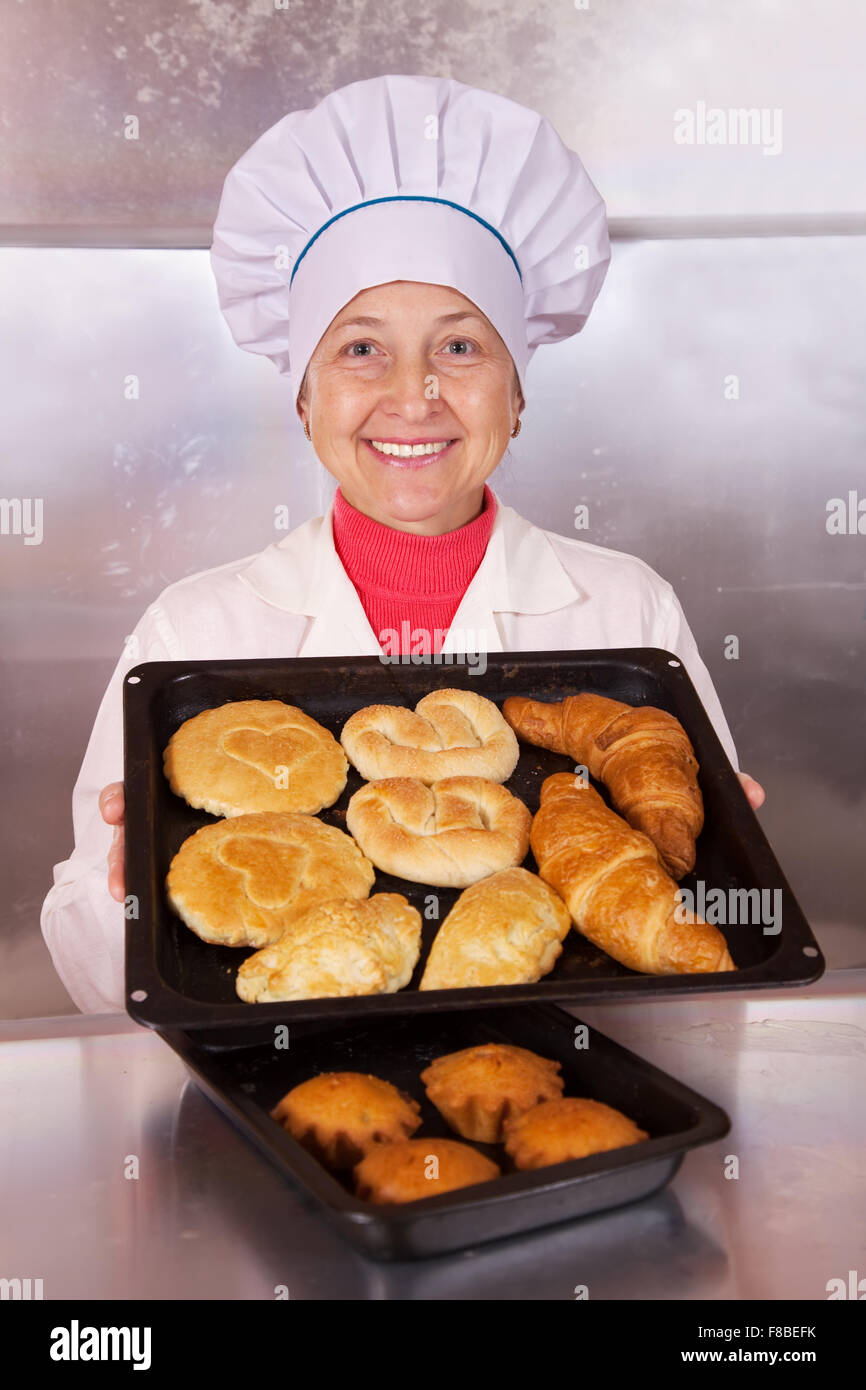 Baker with fresh pastries at bakery Stock Photo - Alamy
