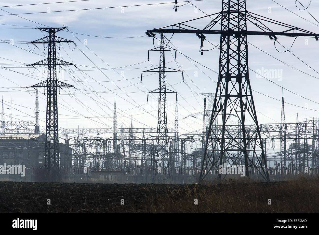 Electricity pylons with distribution power station blue cloudy sky ...