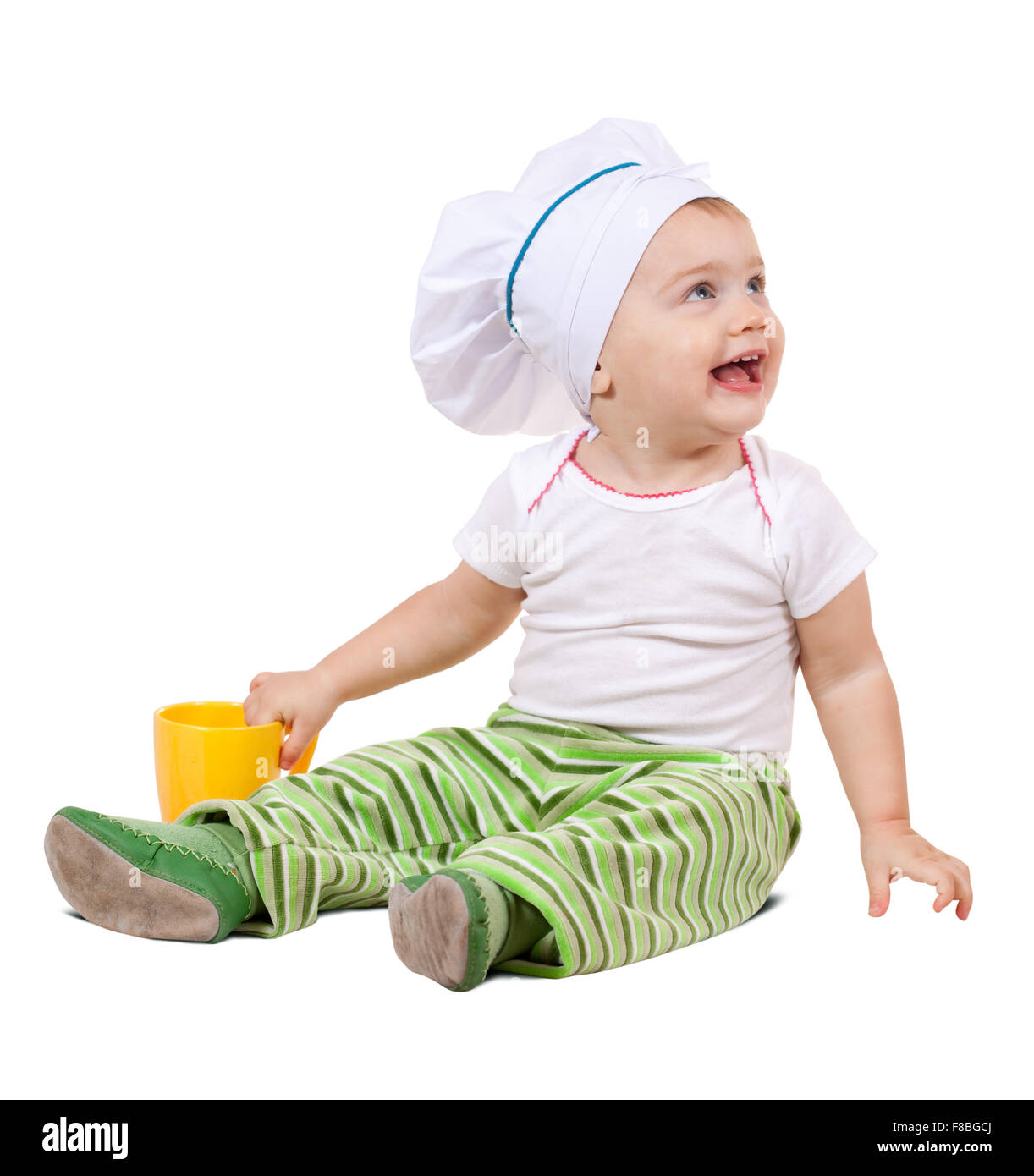 Baby cook in toque with cup over white background Stock Photo - Alamy