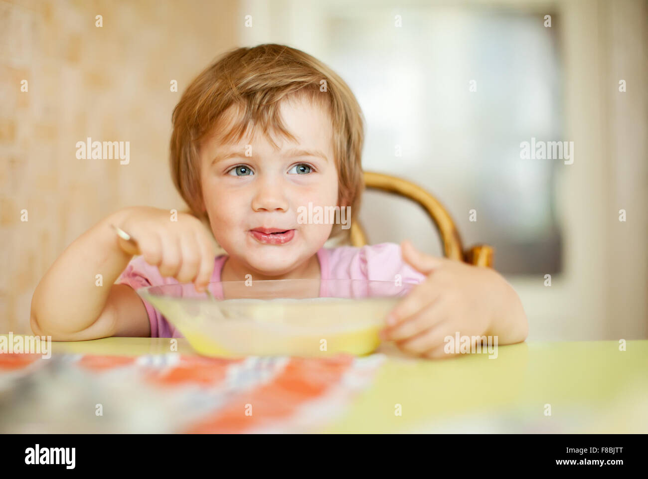 child eats with spoon in home Stock Photo - Alamy