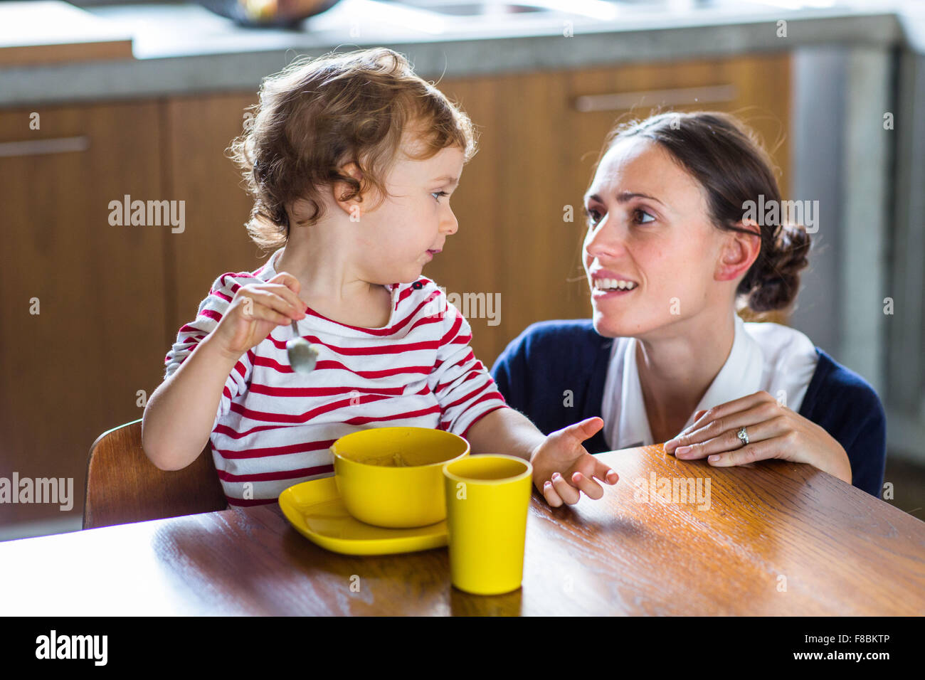 24 month old baby girl eating alone. Independence training Stock Photo ...