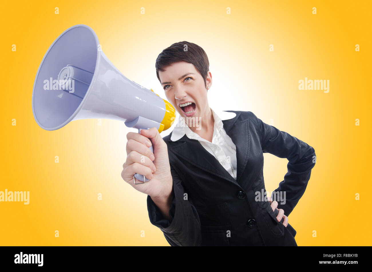 Young business lady screaming to loudspeaker Stock Photo - Alamy
