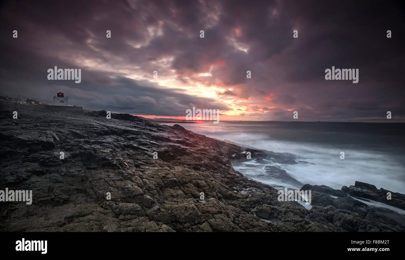 The sun setting in the distance at trinity house light station on stag ...