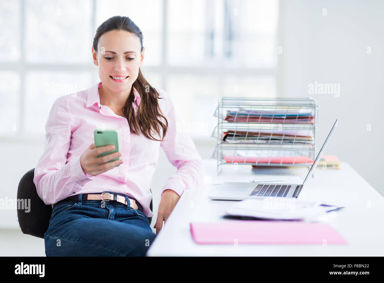 Woman with her cell phone Stock Photo - Alamy