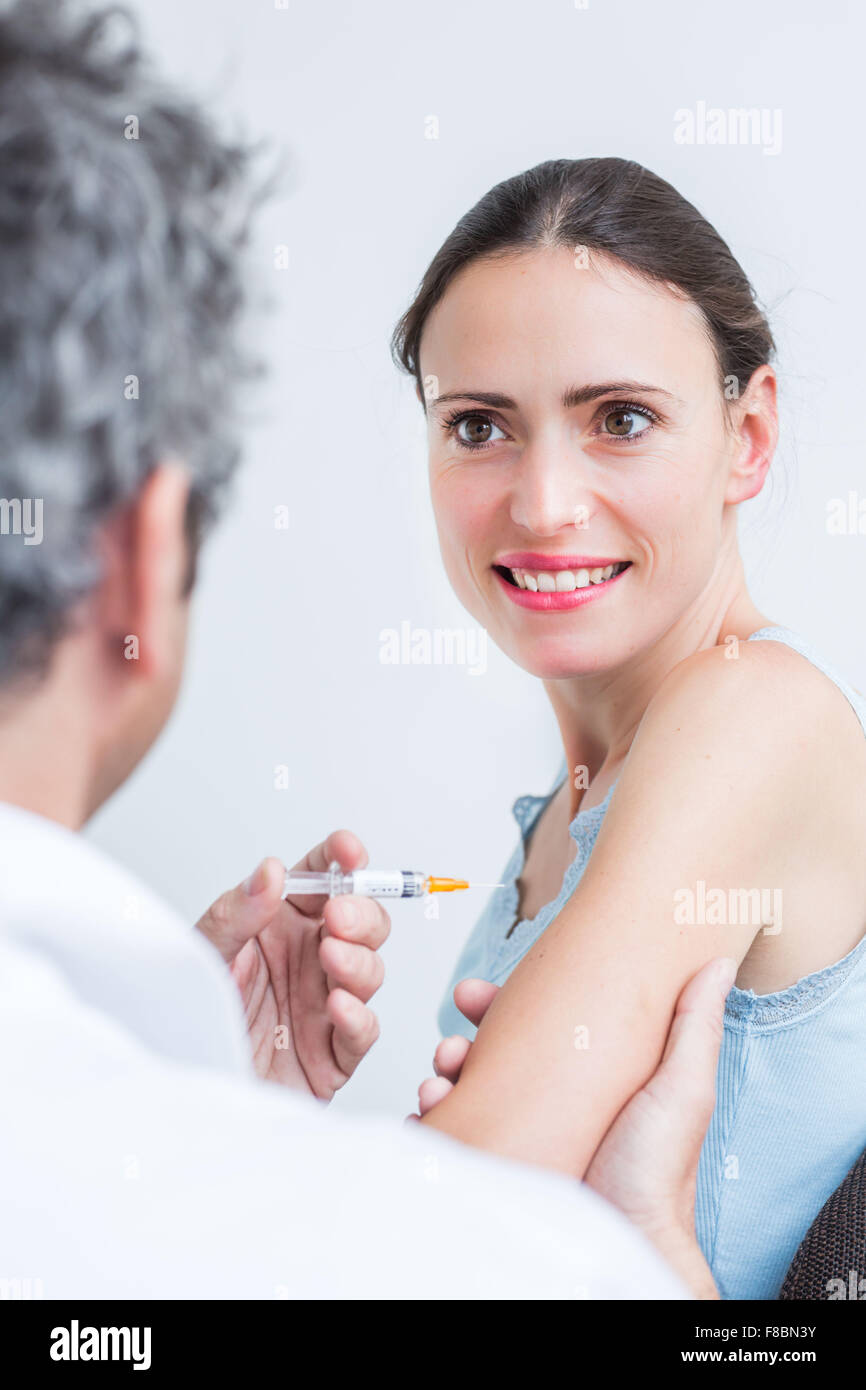 Woman receiving vaccination Stock Photo - Alamy