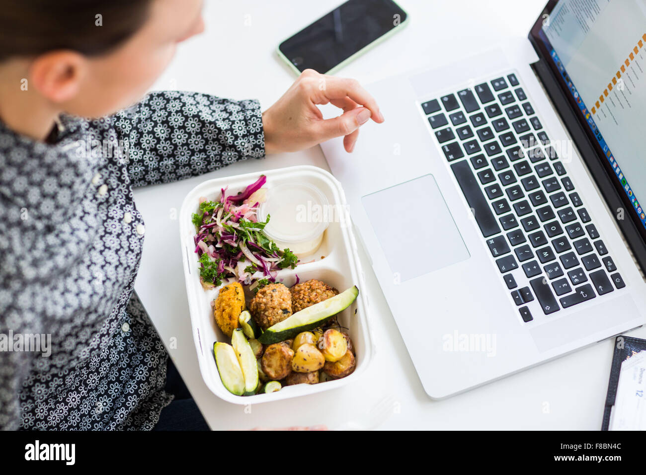 Woman eating bento at work Stock Photo - Alamy