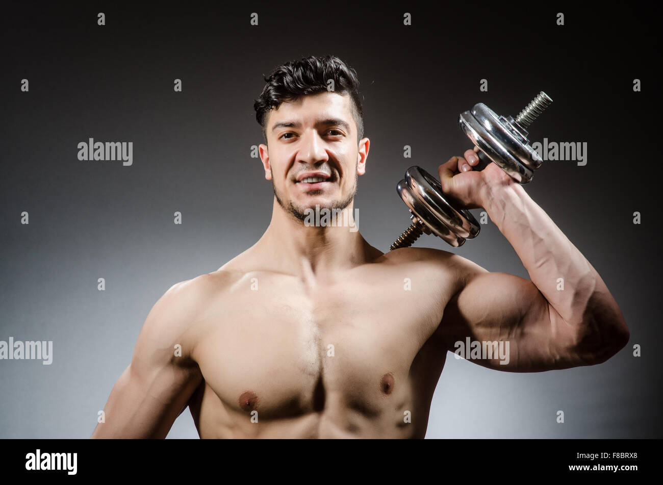 Muscular ripped bodybuilder with dumbbells Stock Photo - Alamy