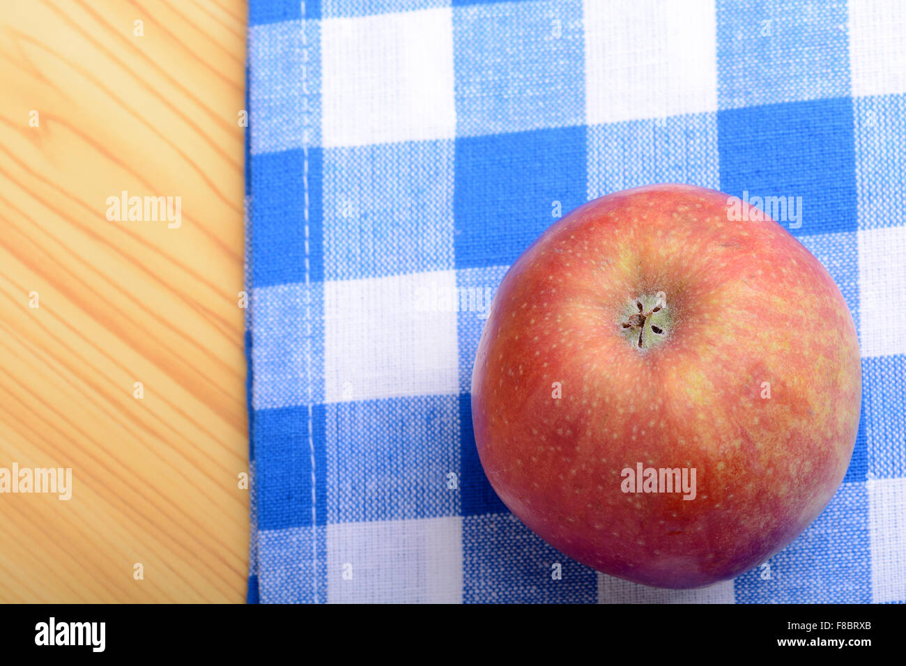Red apple top view on blue material background Stock Photo - Alamy