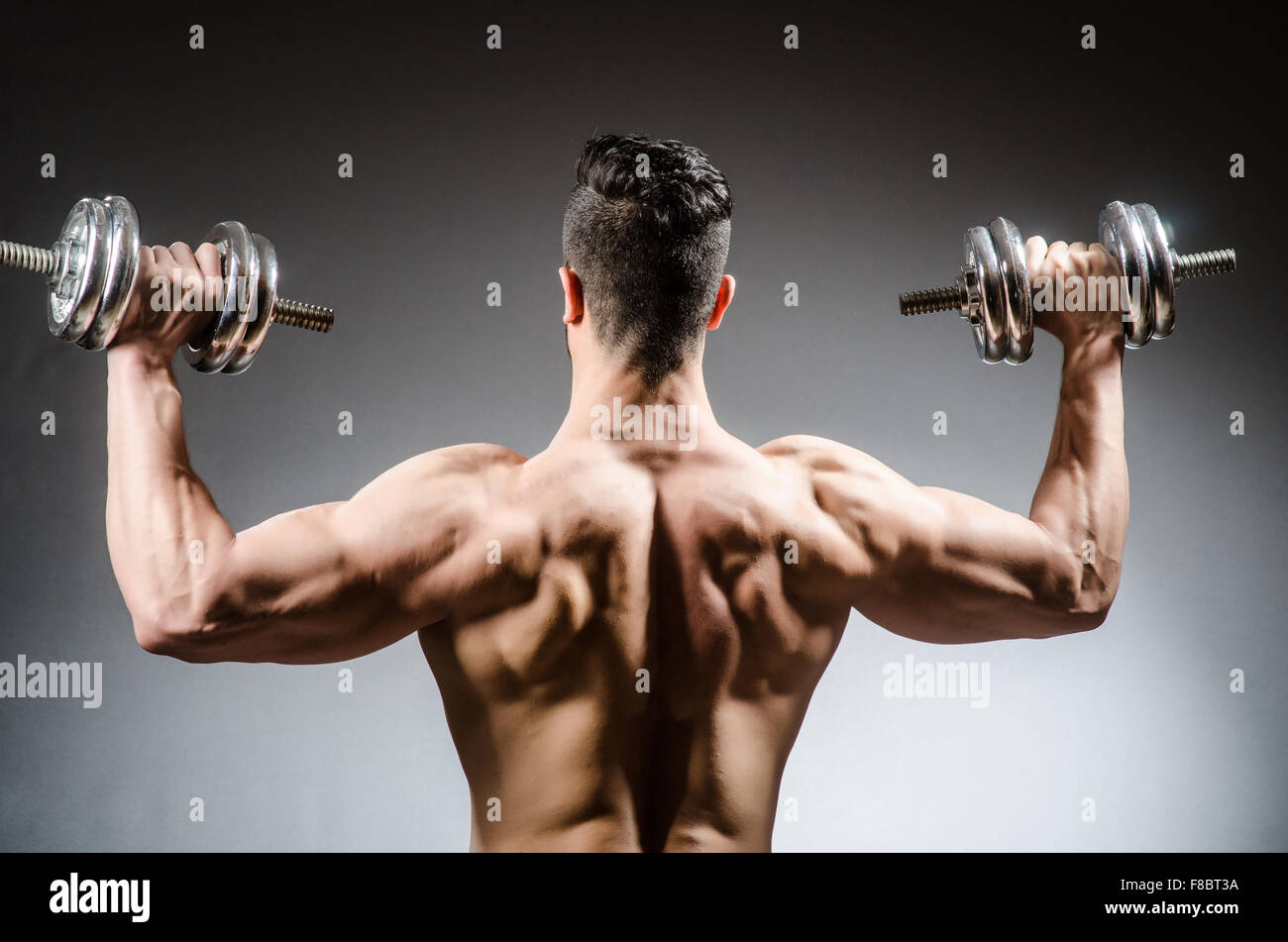 Muscular ripped bodybuilder with dumbbells Stock Photo - Alamy