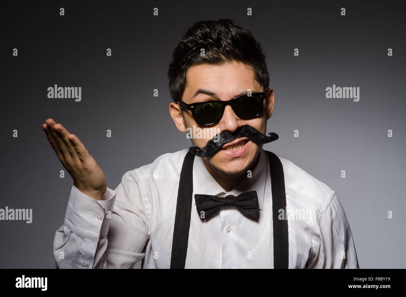 Young man in cool sunglasses isolated on gray Stock Photo - Alamy