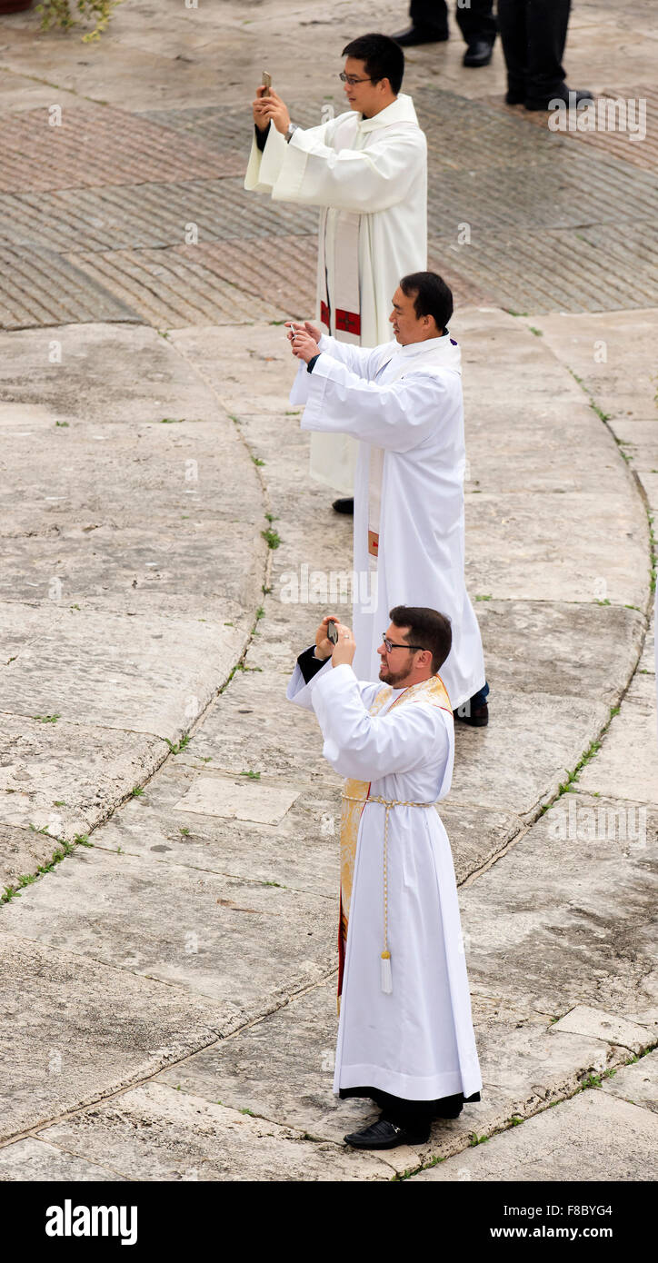 Vatican City. 8th December, 2015. Priests make pictures before the Holy ...