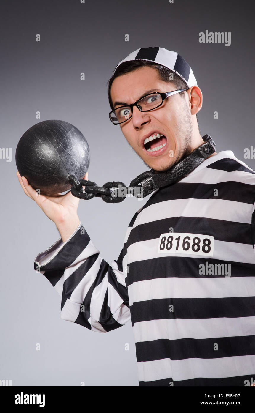 Funny prisoner in chains isolated on gray Stock Photo - Alamy