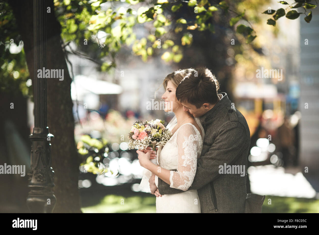 Groom hugs bride Stock Photo - Alamy