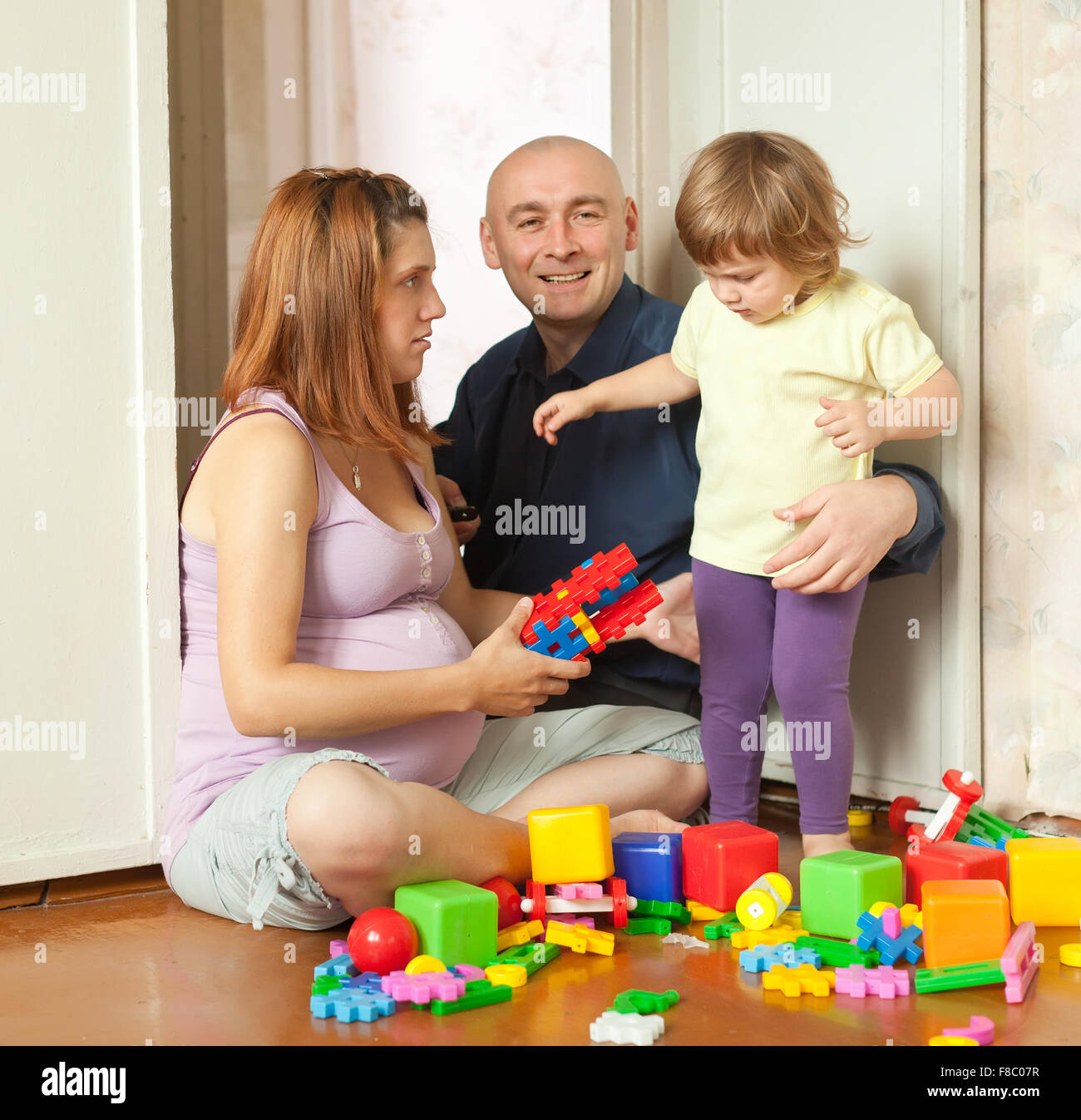 Portrait of family of three in home Stock Photo - Alamy