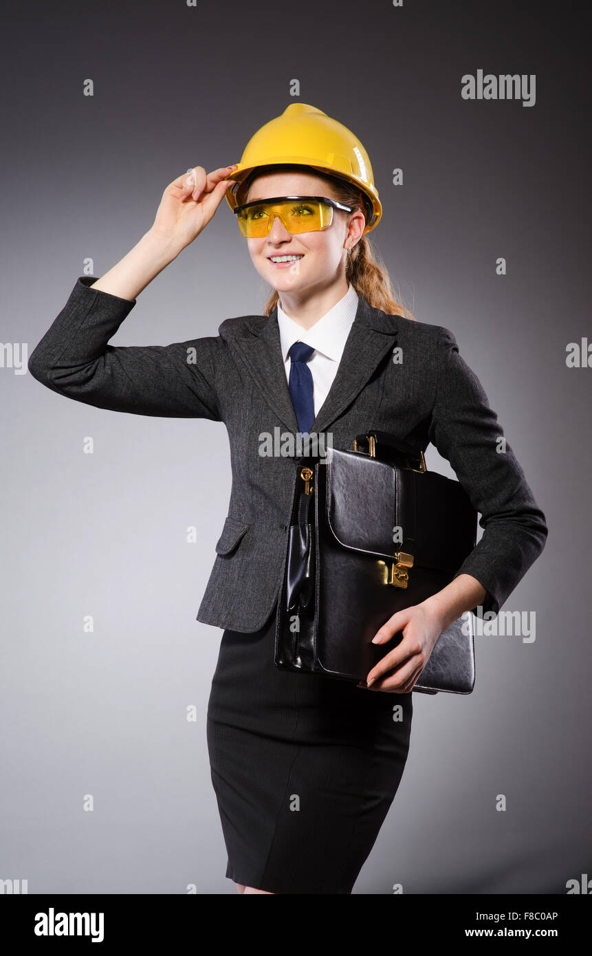 Female engineer with helmet isolated on gray Stock Photo - Alamy