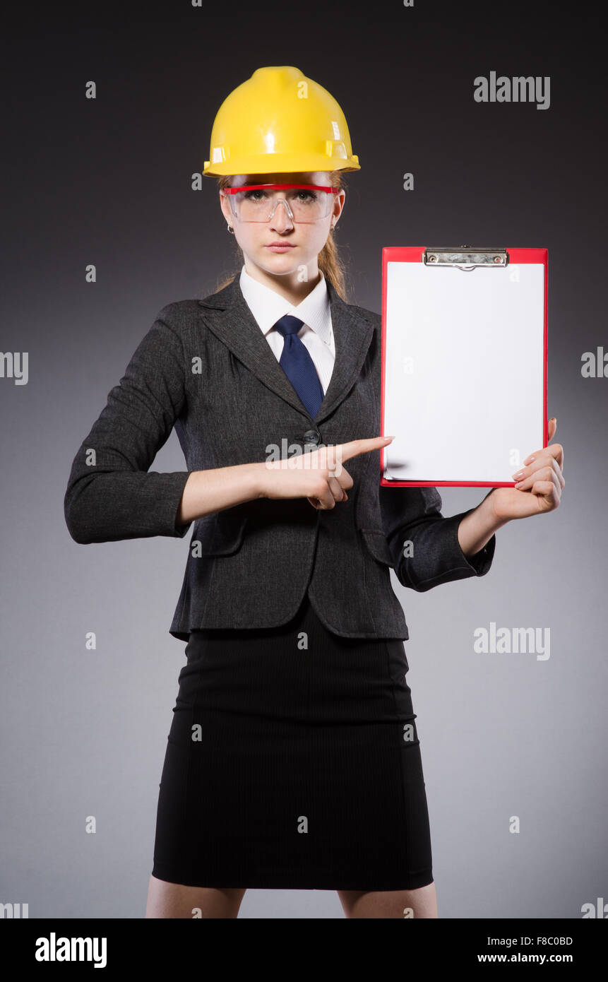 Female engineer with helmet isolated on gray Stock Photo - Alamy