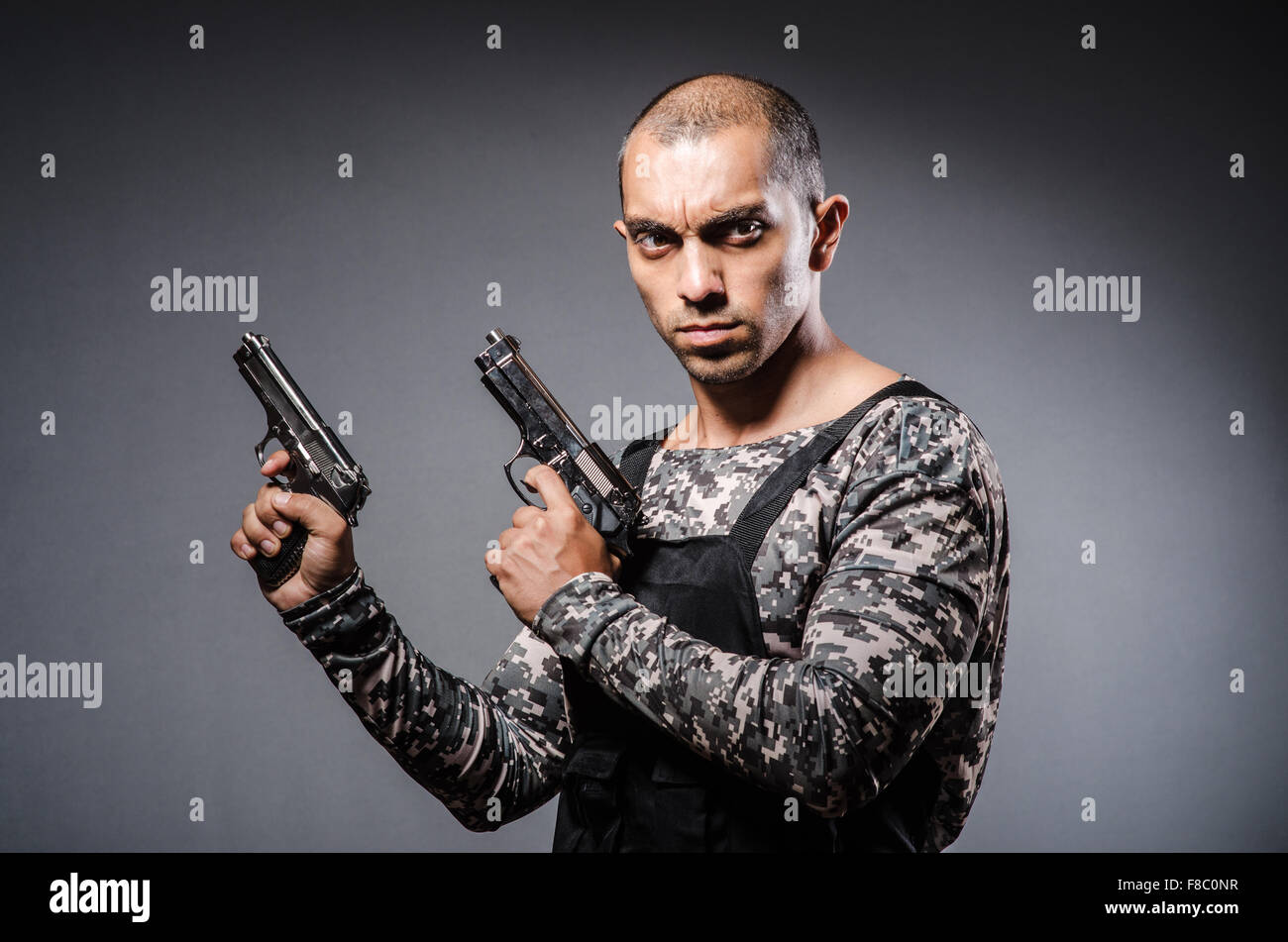 Soldier with guns against dark background Stock Photo - Alamy