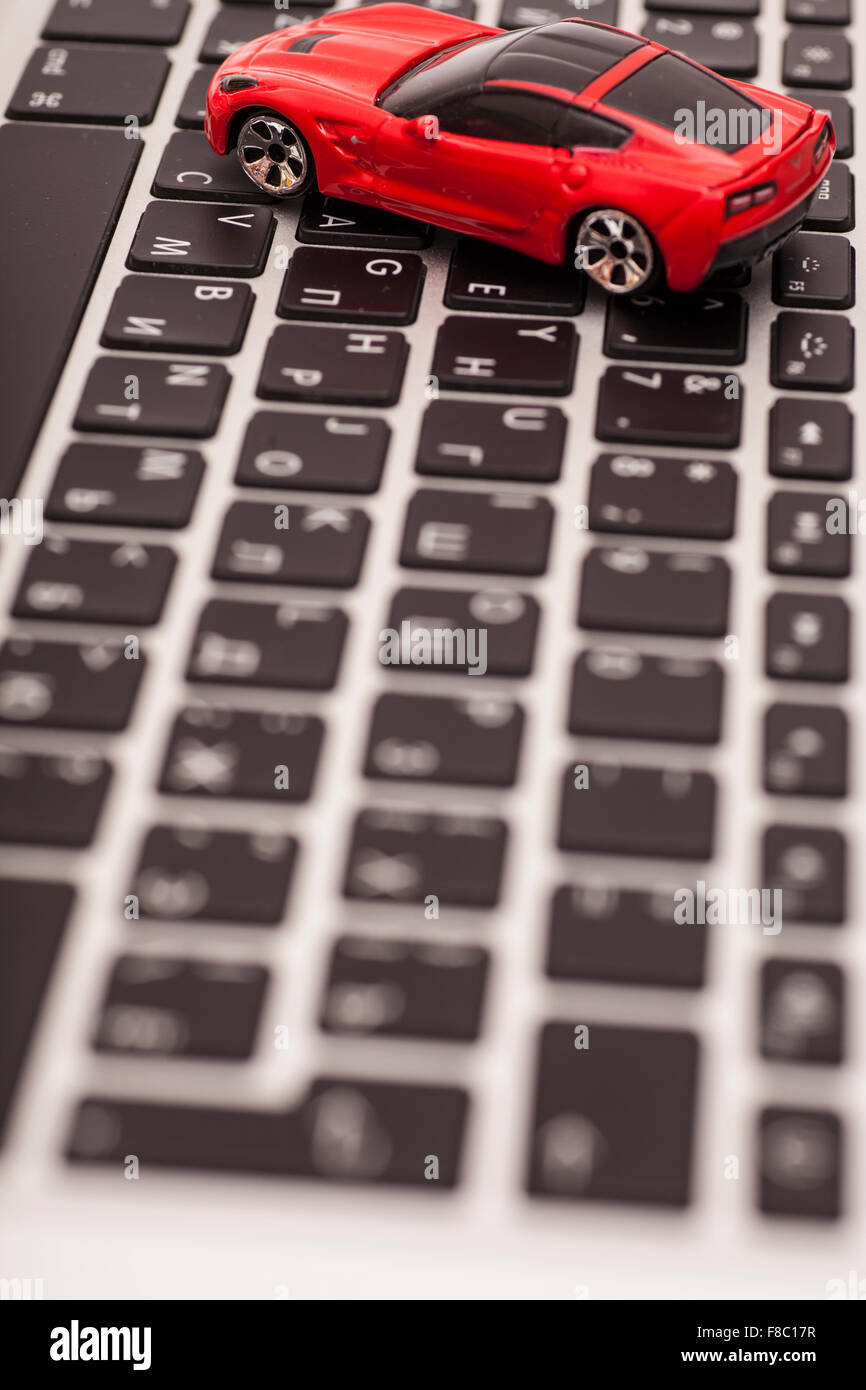 Toy car over laptop keyboard Stock Photo - Alamy