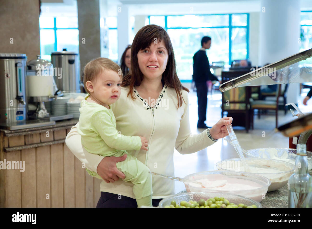 Mother with child takes milk food in hotel buffet Stock Photo - Alamy