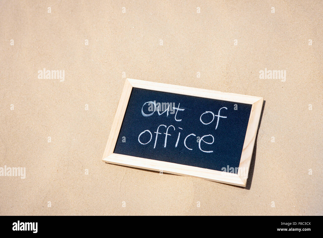 High angle copy space with word Out of Office written in a frame on ...