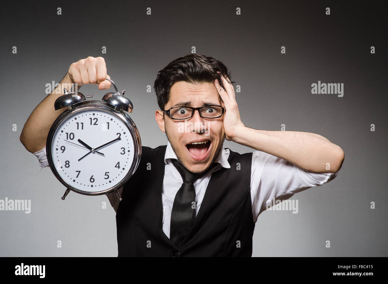 Businessman with clock in time concept Stock Photo - Alamy