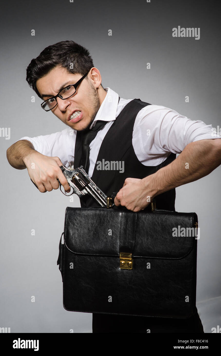 Man with gun and briefcase Stock Photo - Alamy