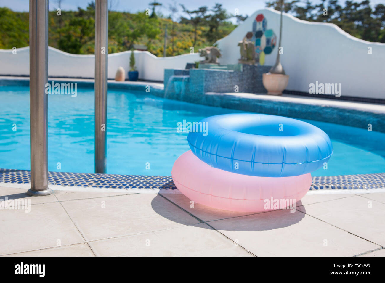 Two ring tubes on the floor with the background of swimming pool Stock ...