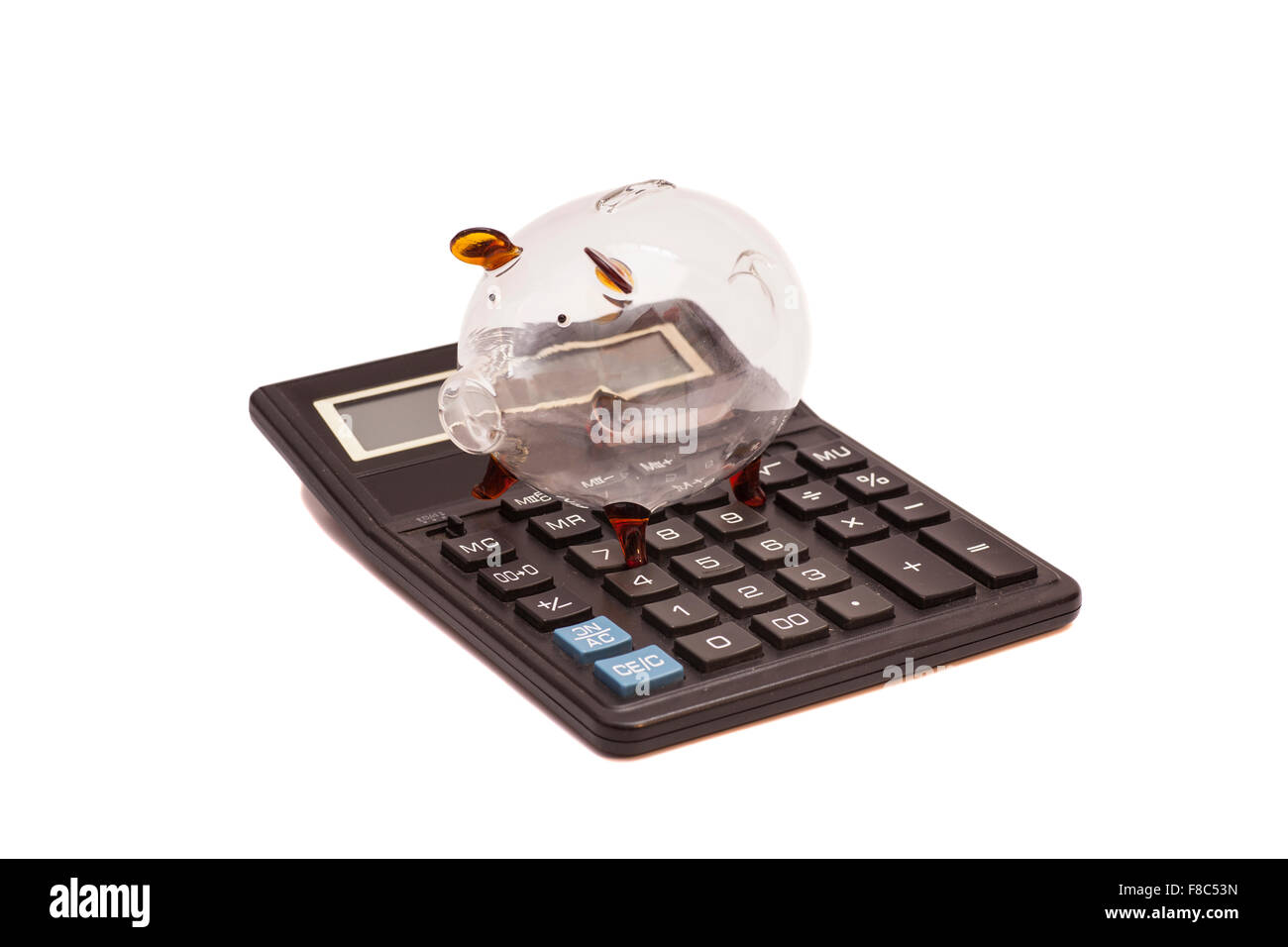 Piggy bank and calculator isolated on white background Stock Photo - Alamy