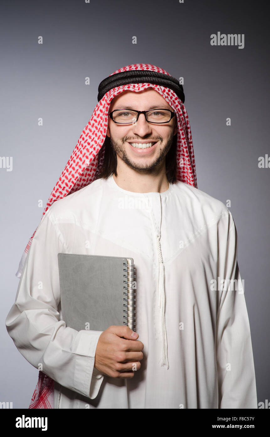 Arab student with book in education concept Stock Photo - Alamy