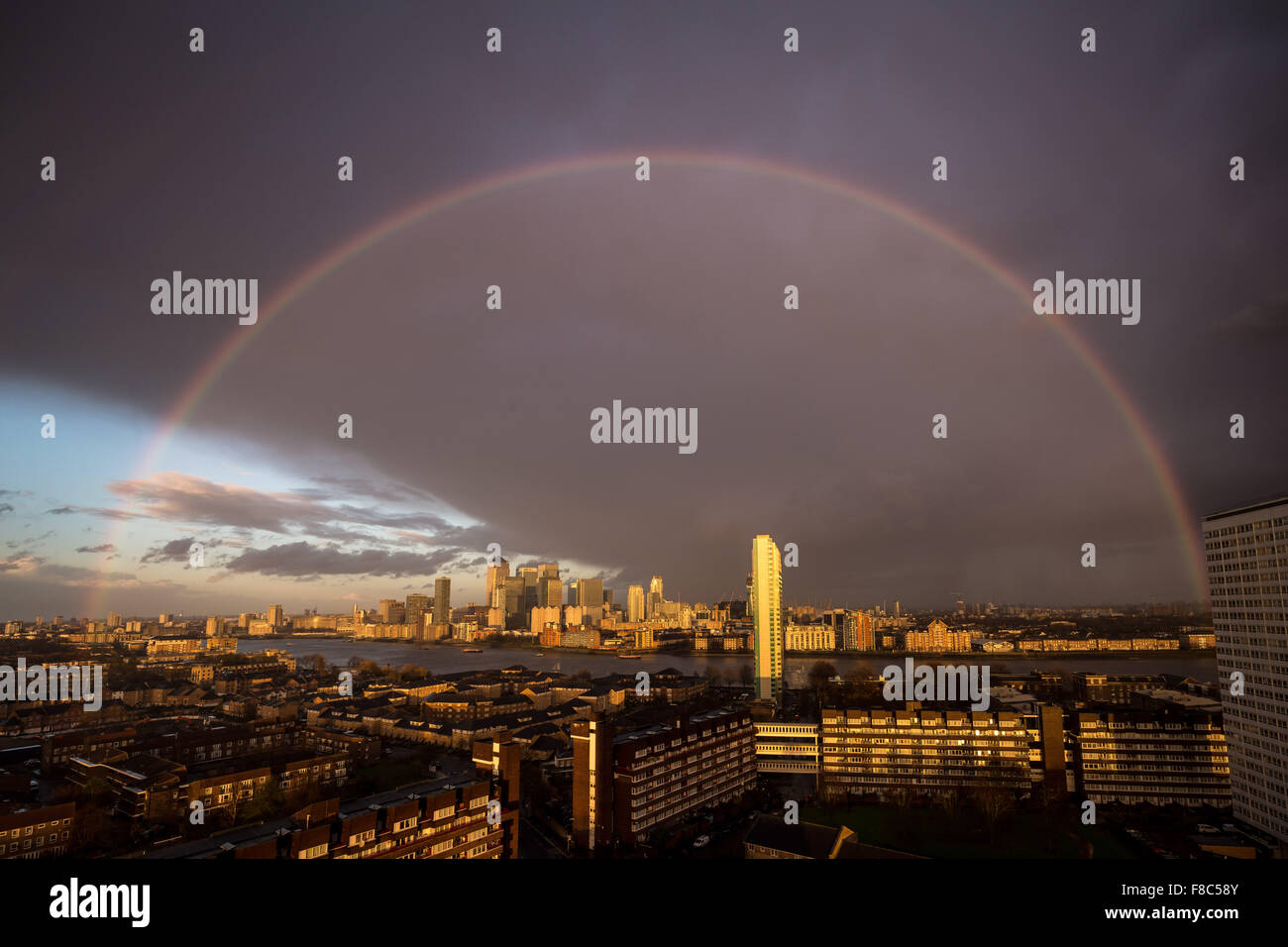 London, UK. 8th December, 2015. UK Weather: Rainbow breaks after ...