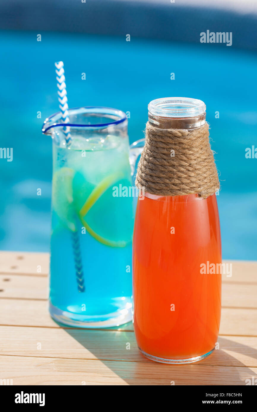 Blue lemonade and orange juice out of focus Stock Photo - Alamy